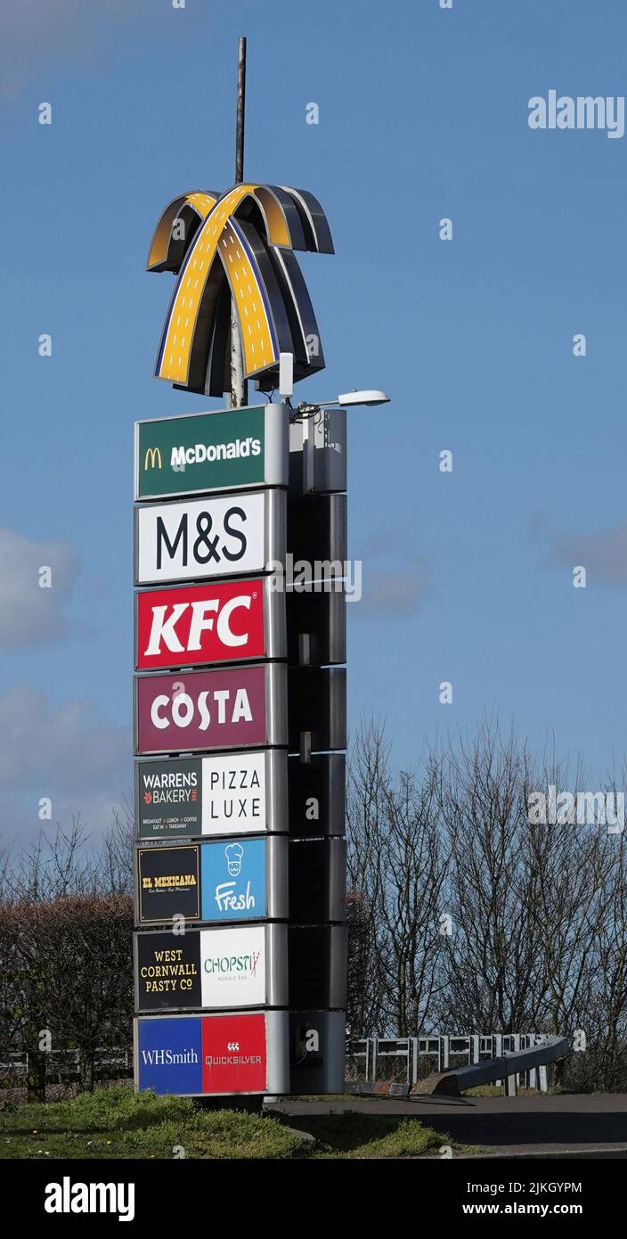A Vertical shot of a signboard advertising the various commercial ...