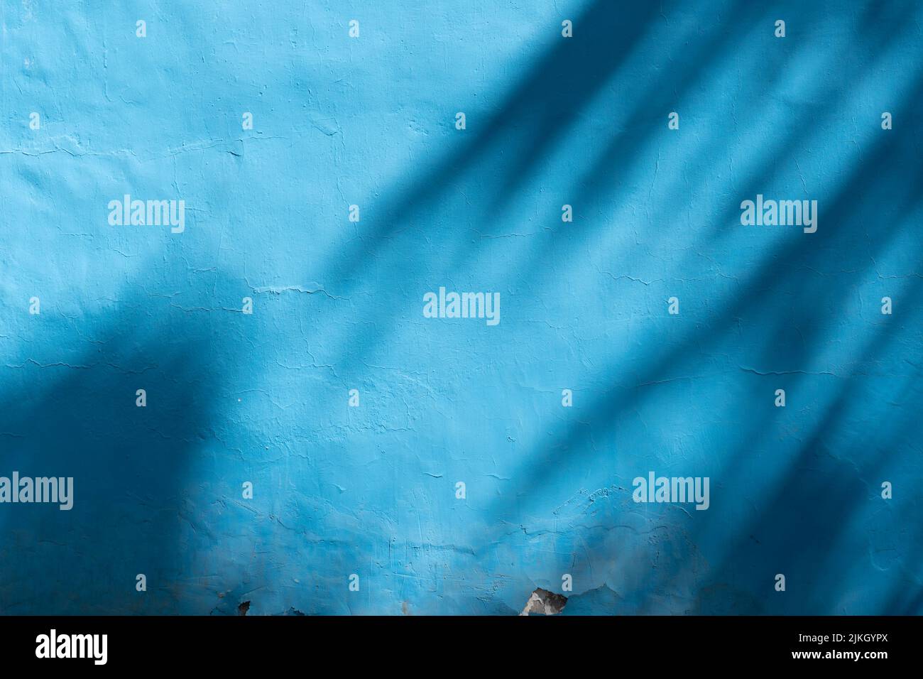 A blue wall surface with shadows for backgrounds Stock Photo - Alamy