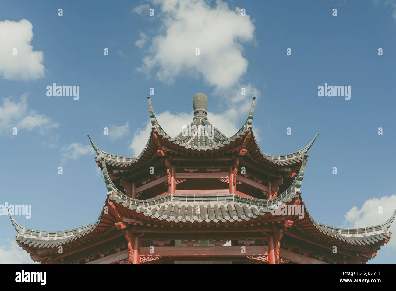 The top of an Asian building against the blue cloudy sky Stock Photo ...