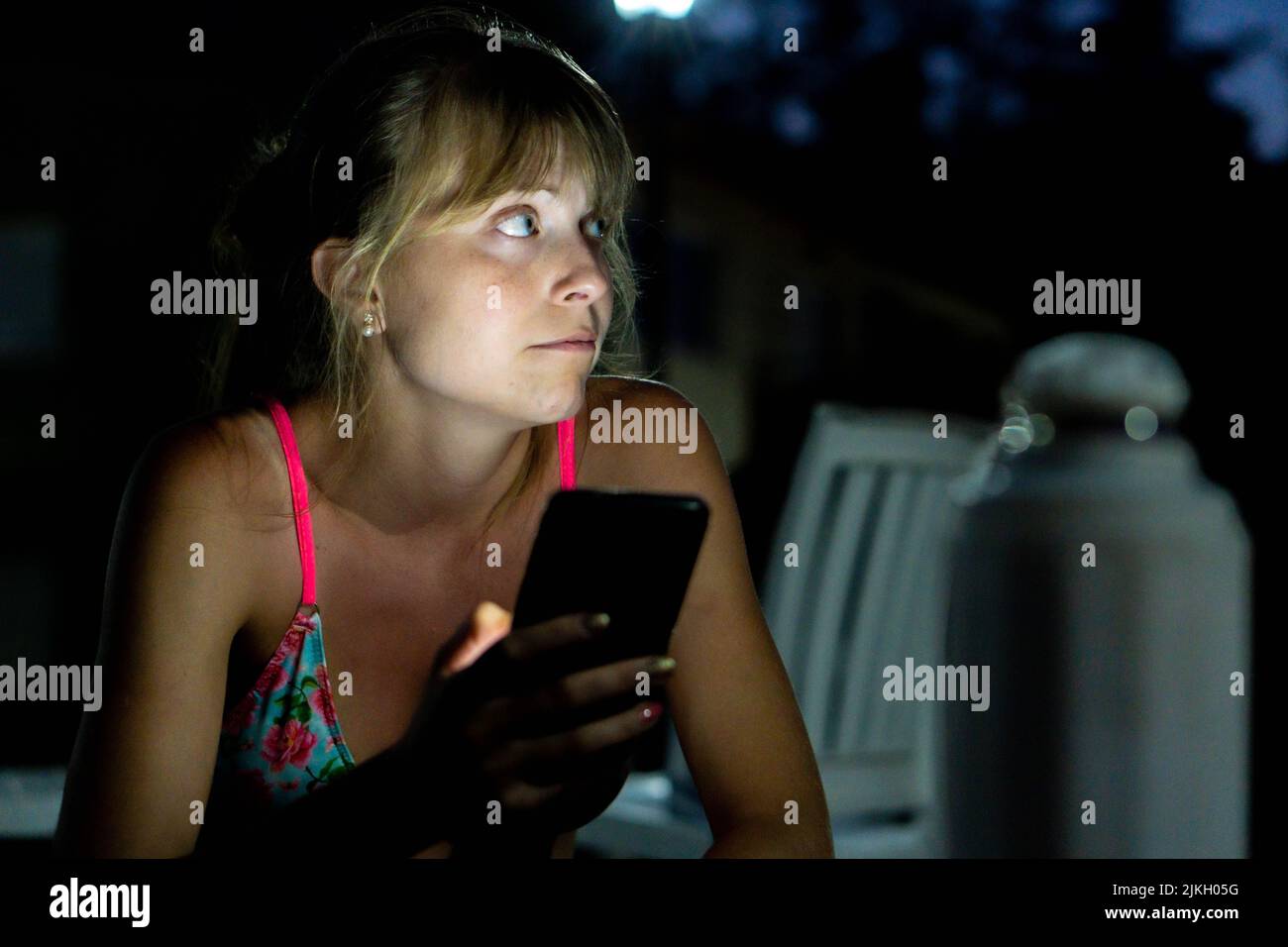 A vertical of a young Caucasian beautiful female scrolling through her ...