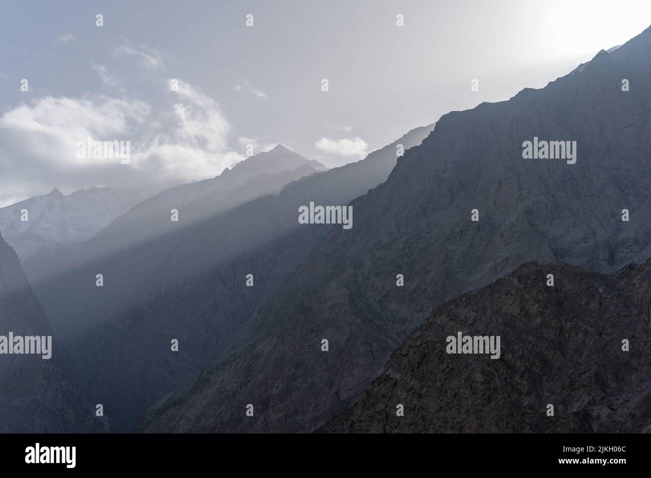 A beautiful mountains landscape with sunlight peeking through the ...
