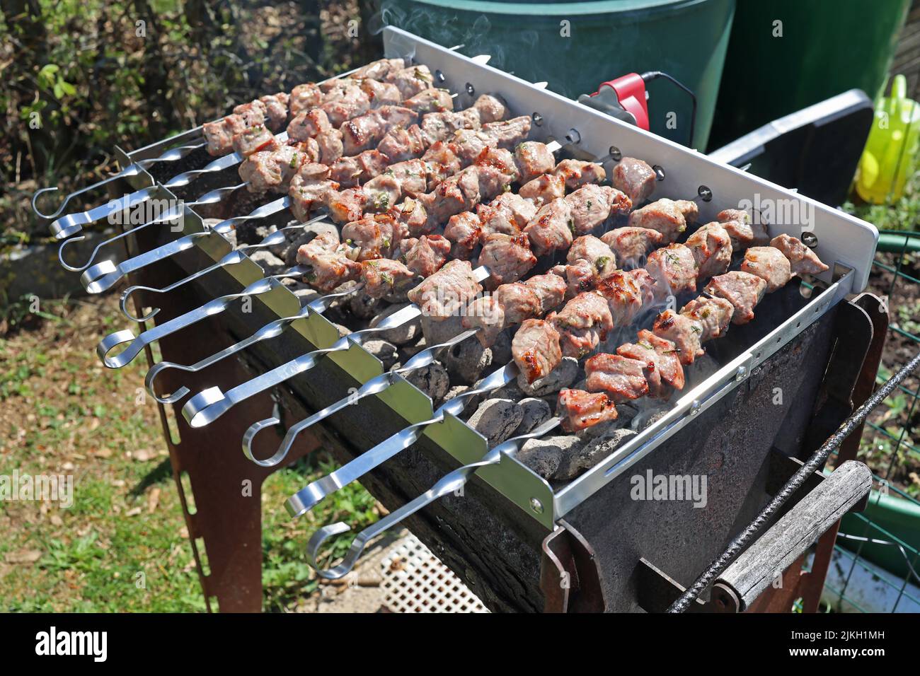 Roasted meat cooked at barbecue with smoke Stock Photo - Alamy