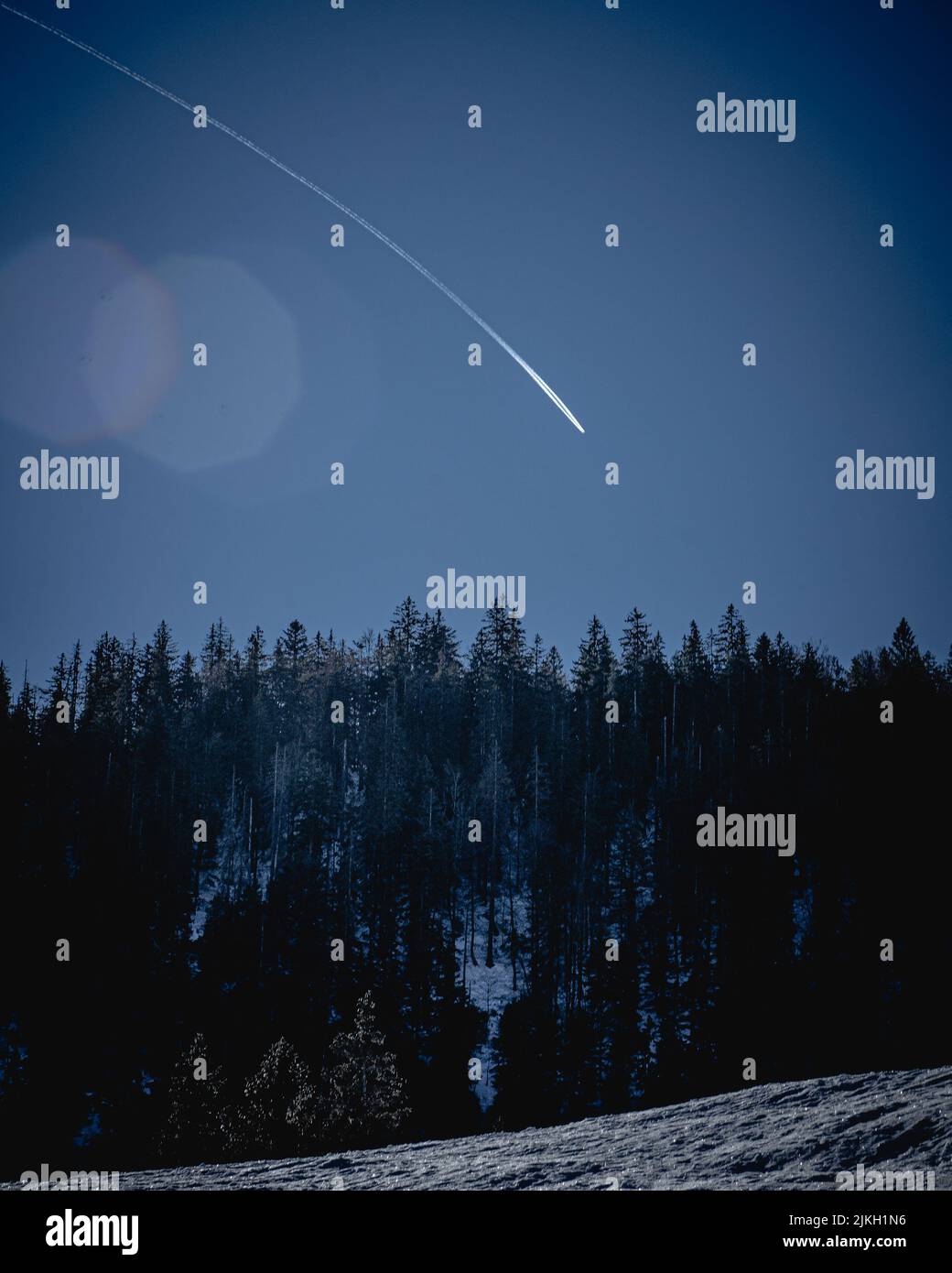 A vertical shot of the blue sky with a shooting star Stock Photo - Alamy