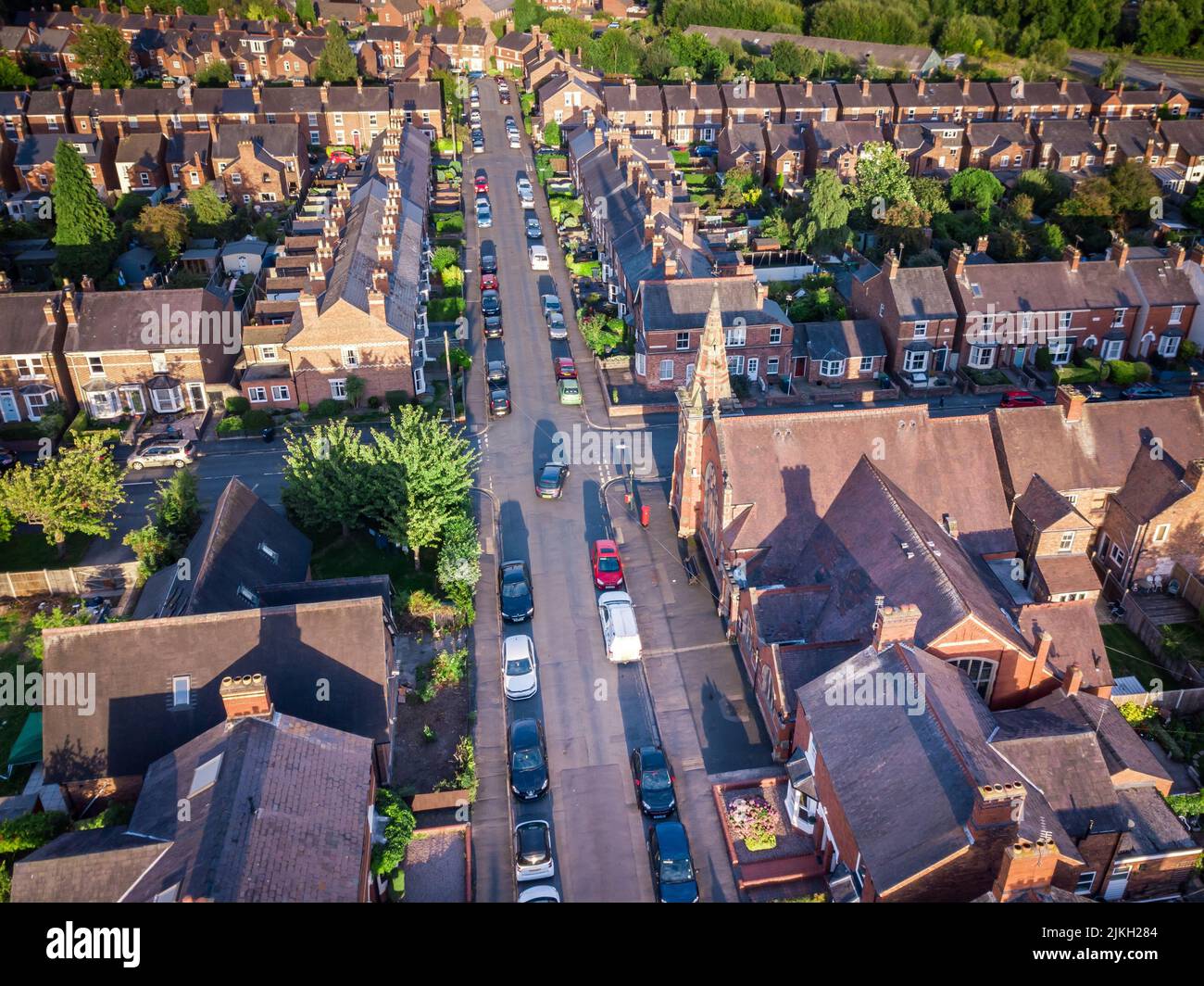 An aerial view of traditional British houses and cars in the street at ...