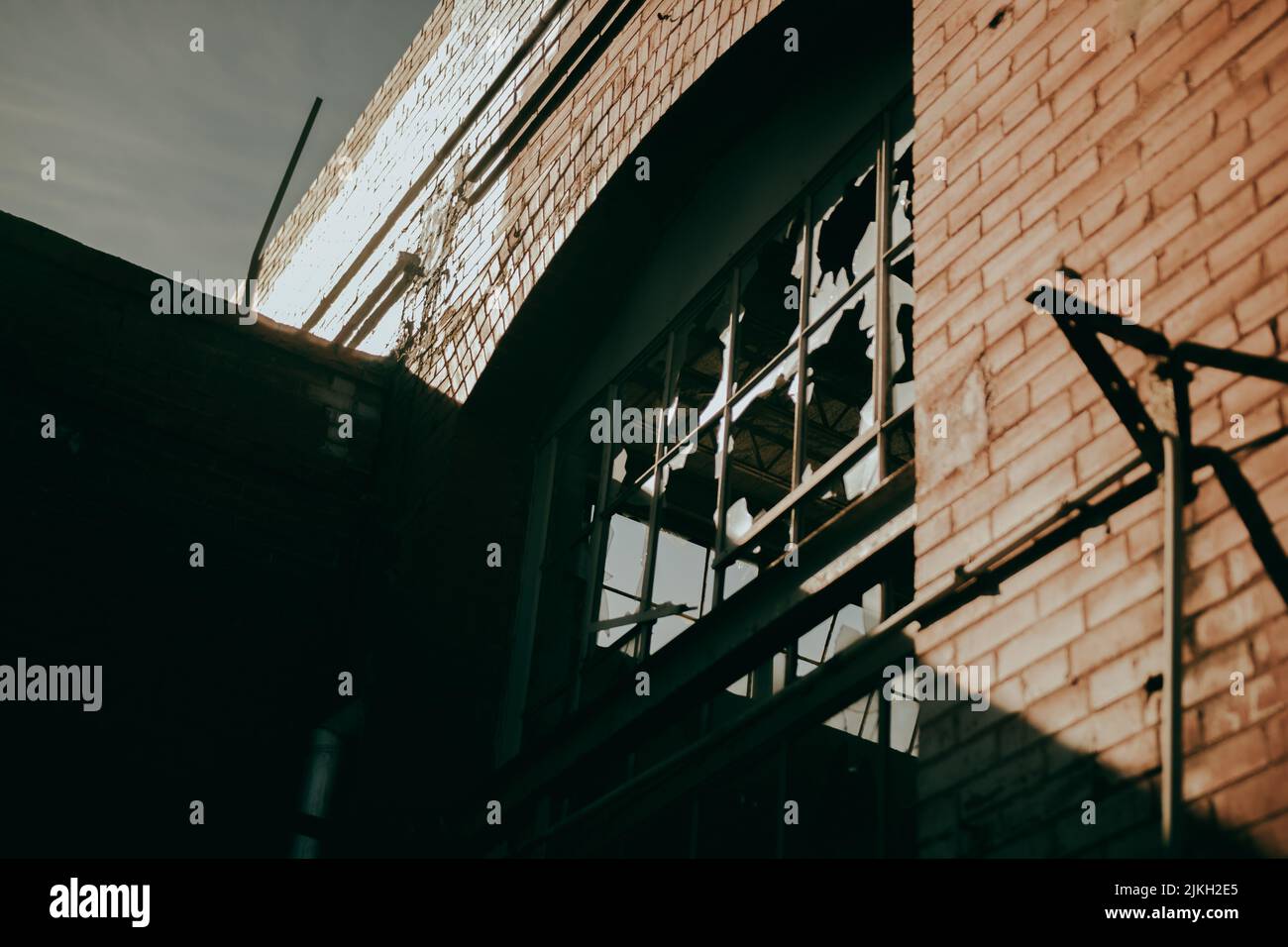 A low angle shot of an old abandoned window with shattered glass Stock ...