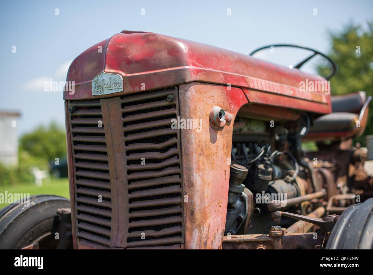 A closeup shot of a rusty old red tractor at a farm in Ontario Stock ...