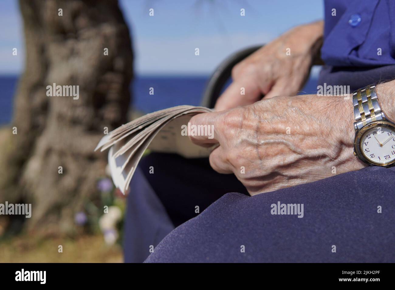 a senior man pointing at something in the newspaper Stock Photo - Alamy