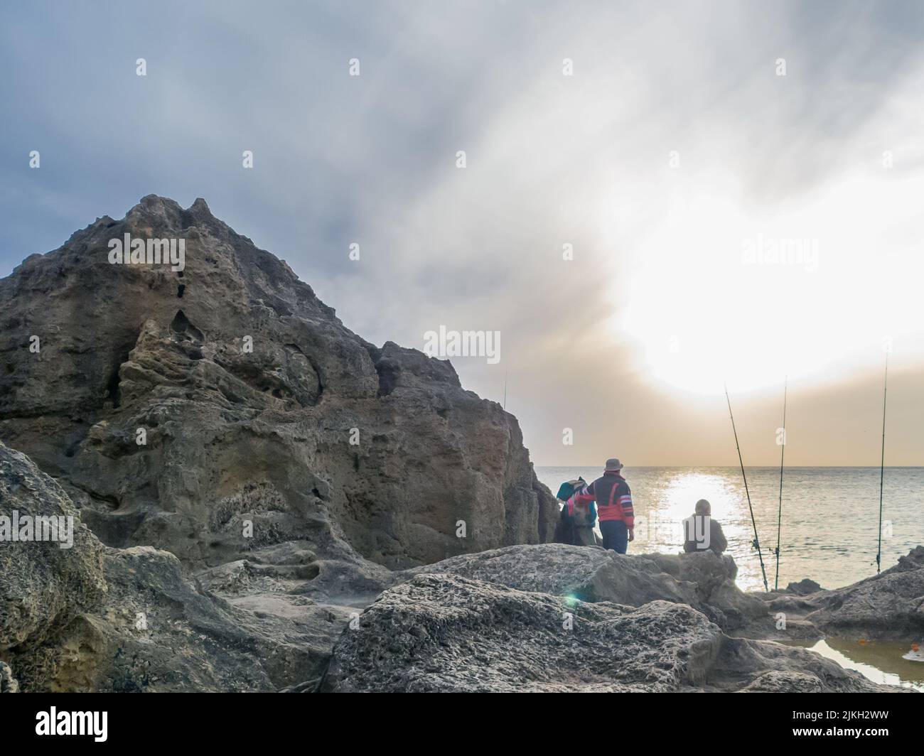 A group of tourists near a cliff on the shore of Tangier, Morocco Stock ...