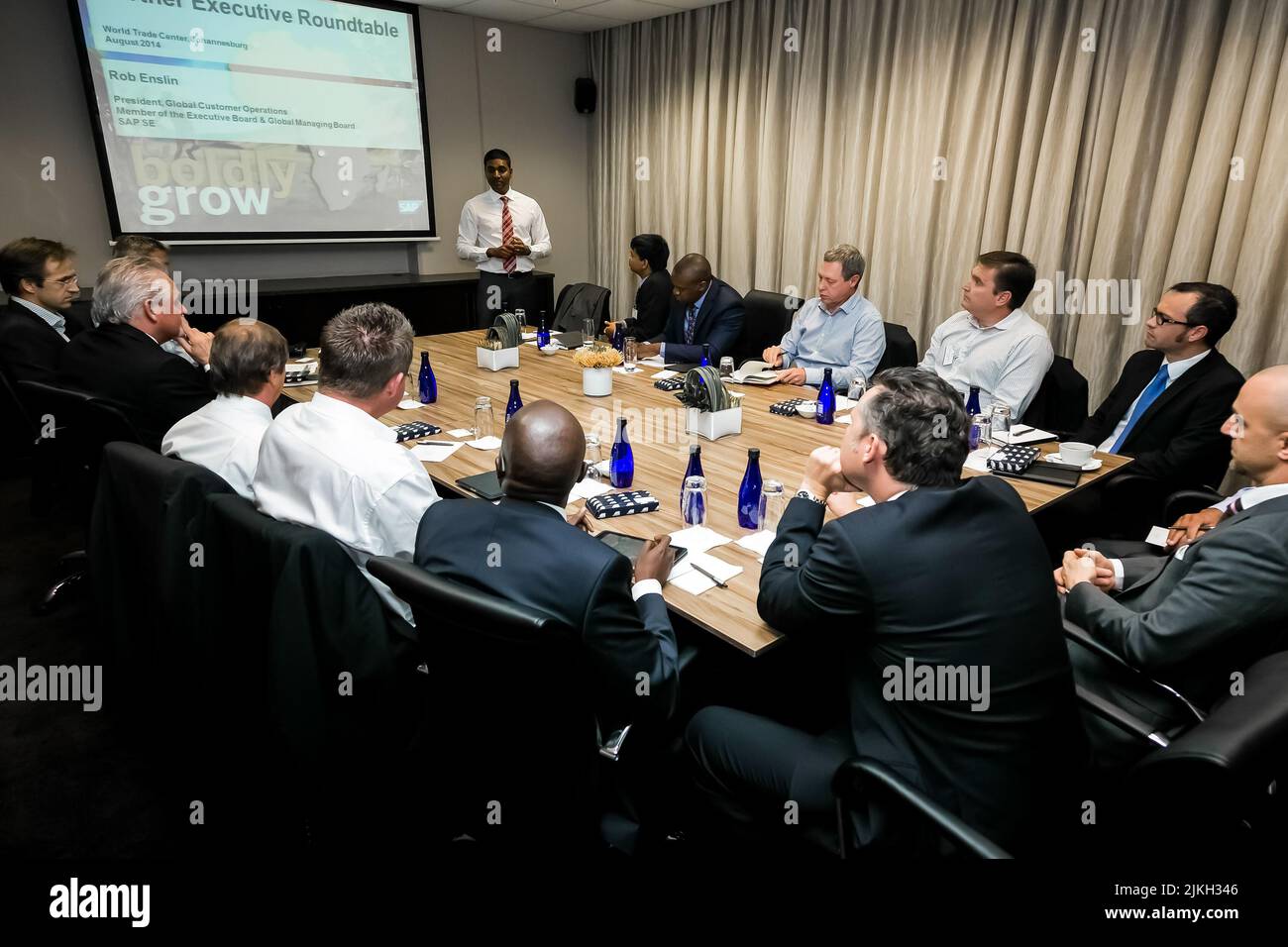 A boardroom meeting and presentation with diverse businessmen in ...
