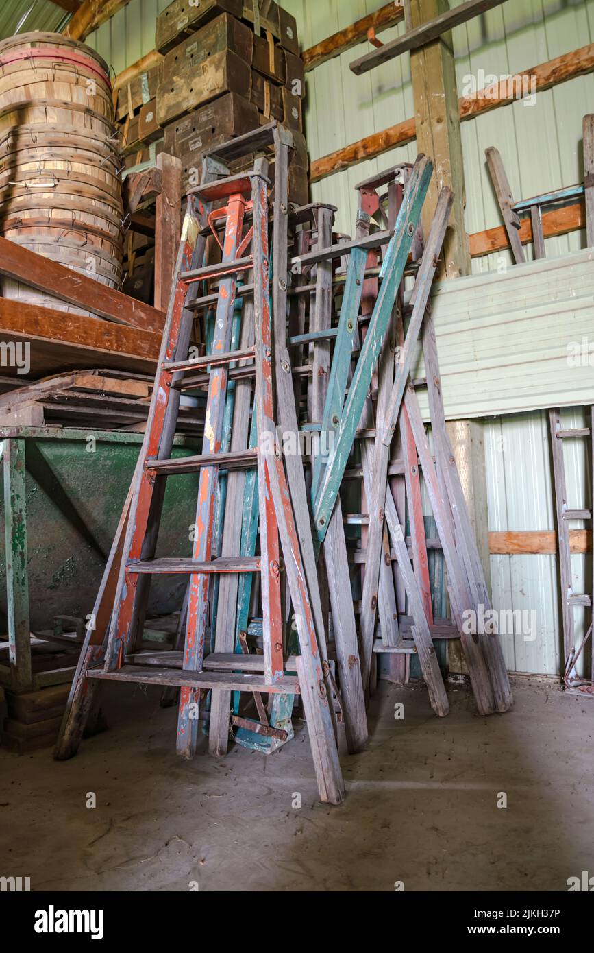 A vertical shot of old ladders leaning against a barn wall Stock Photo ...