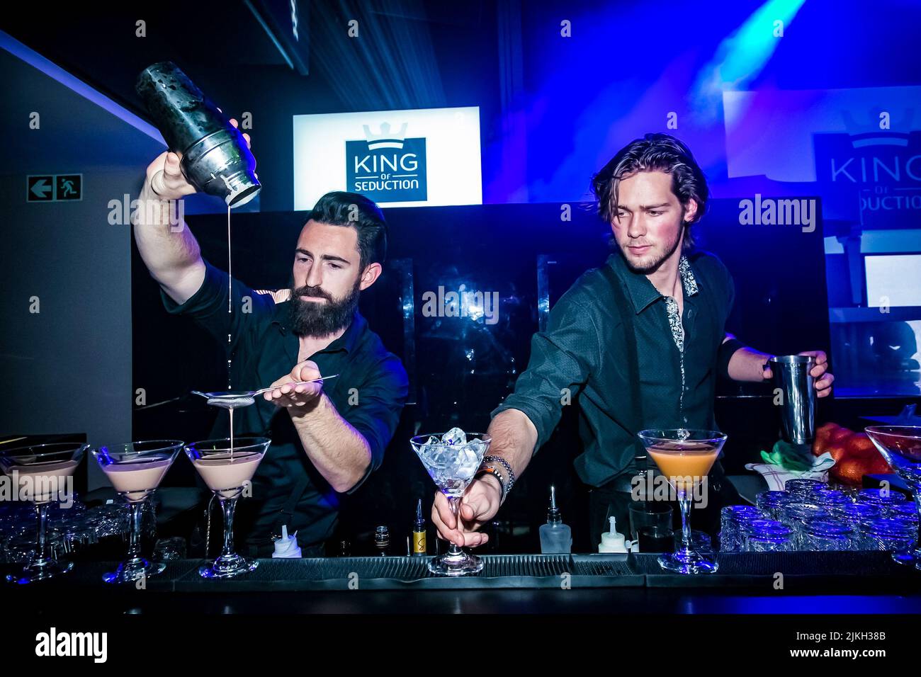 A pair of male mixologists making cocktails at an event in Johannesburg ...