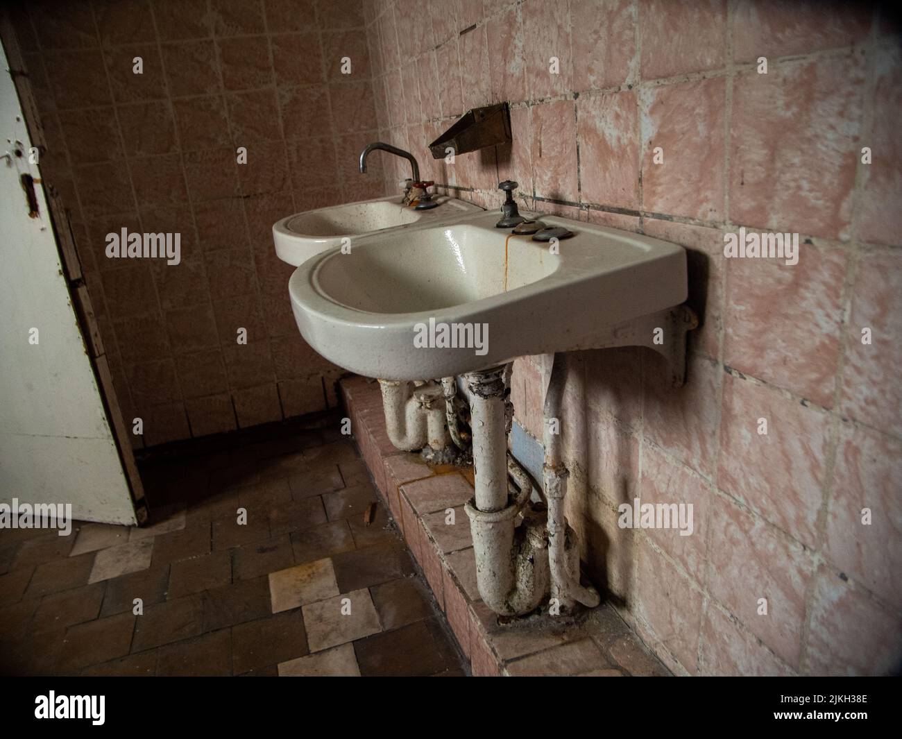 The two old sinks in the bathroom of the abandoned Soviet coal mining ...