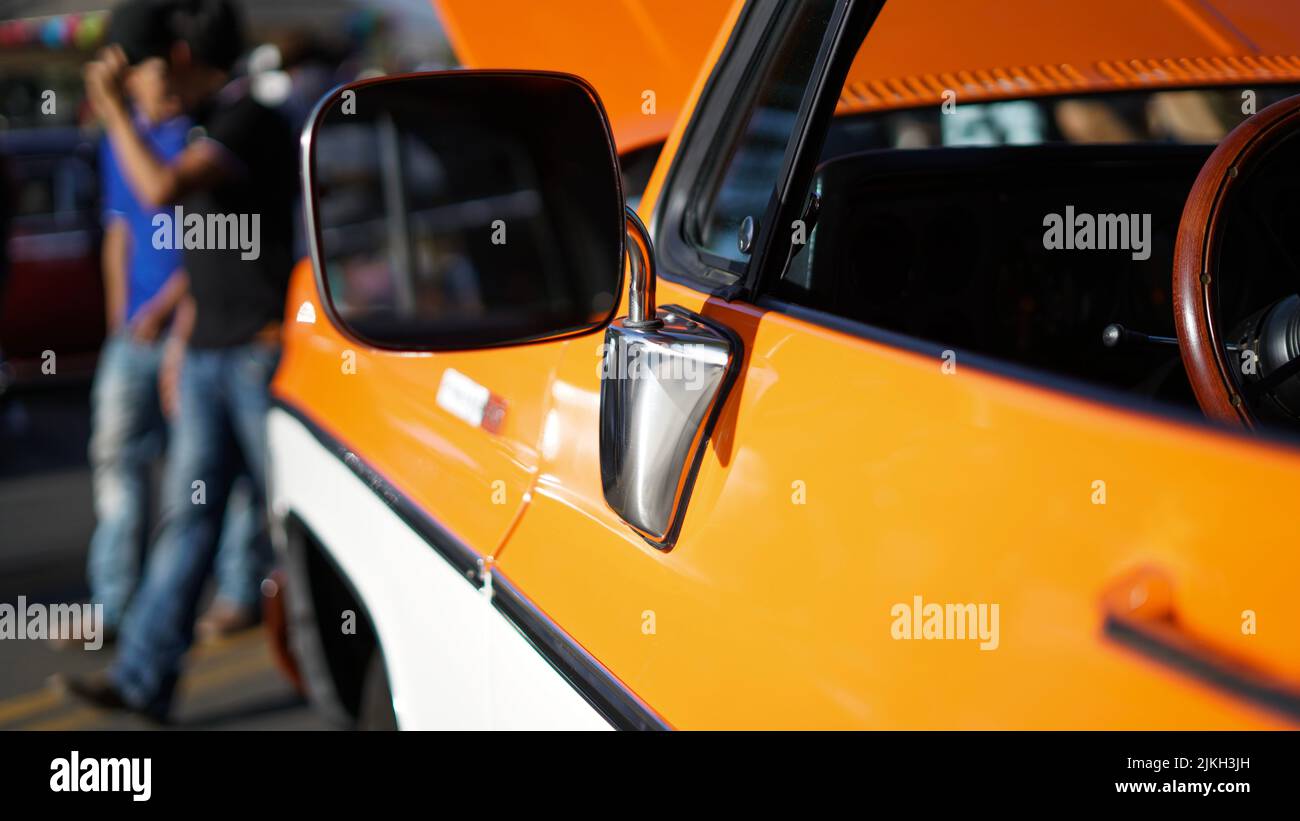 A closeup of a classic car mirror at a car show in Los Angeles, USA ...