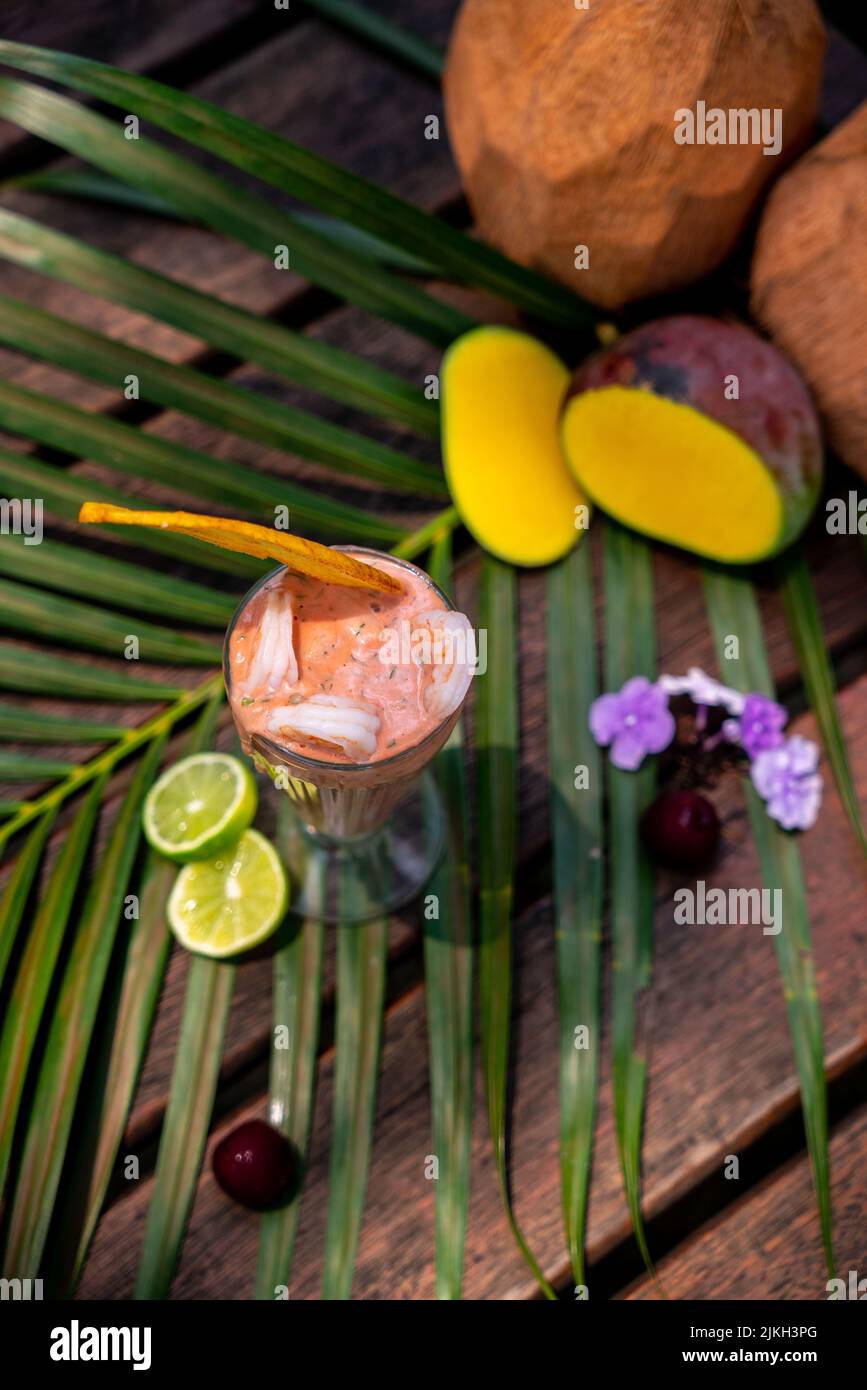 A top view of a cocktail in a glass decorated with plantain and lime ...