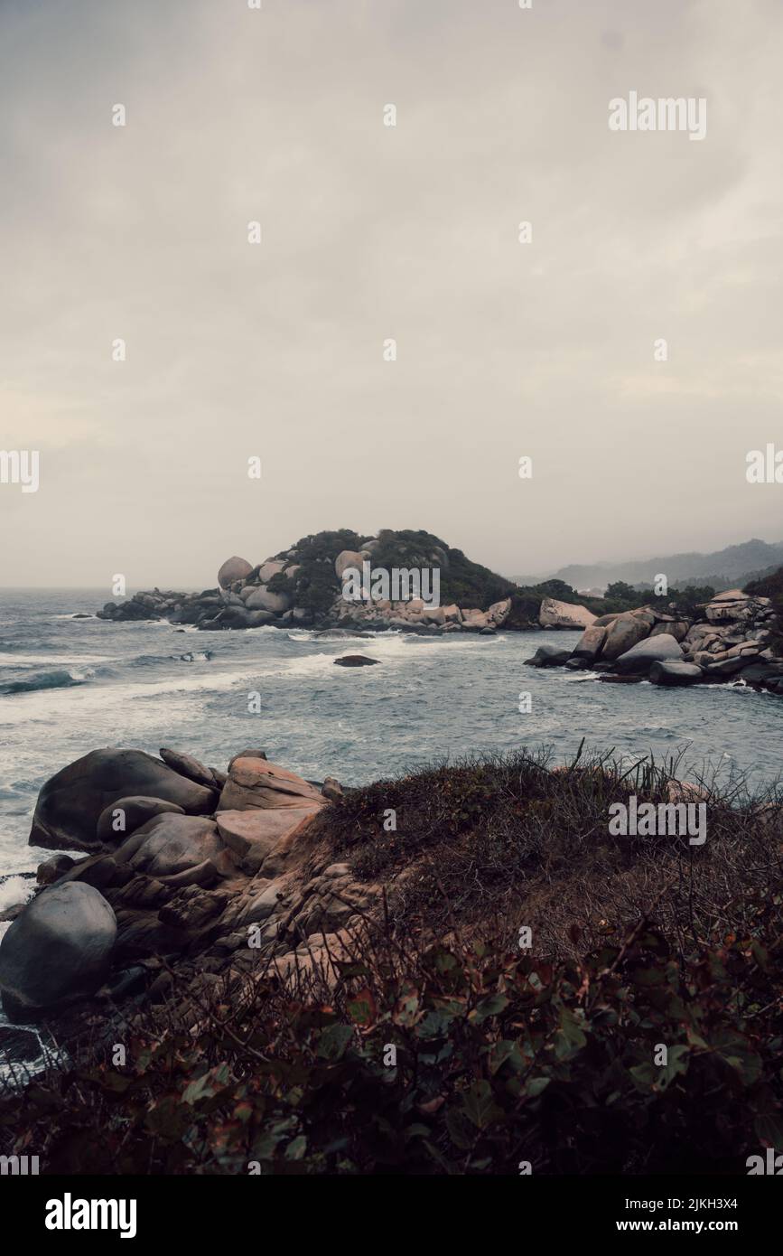 Gloomy cloudy sky over seashore with rocks and boulders on a stormy day ...