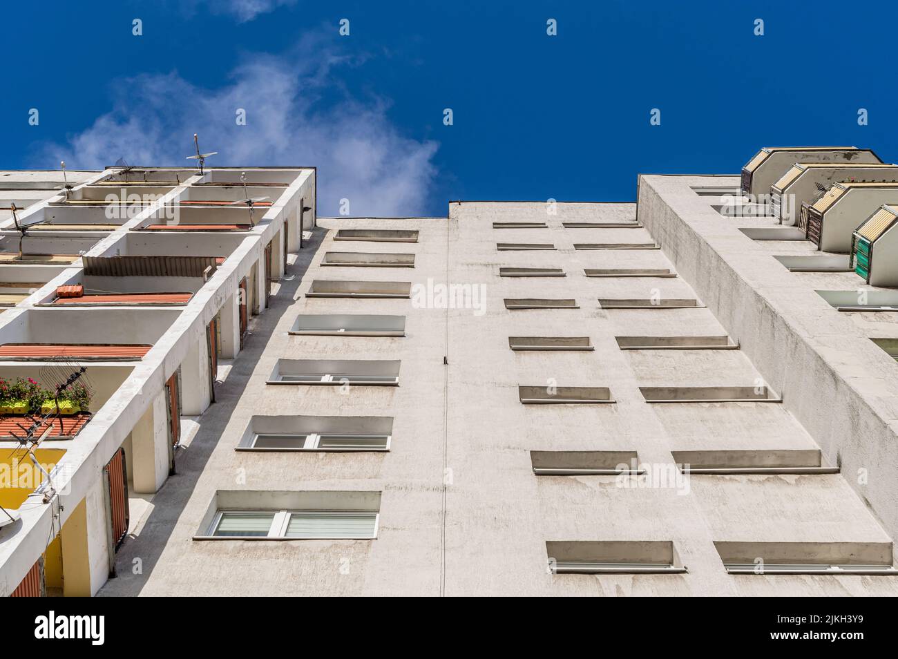 The exterior of a high-rise building with windows and balconies against ...