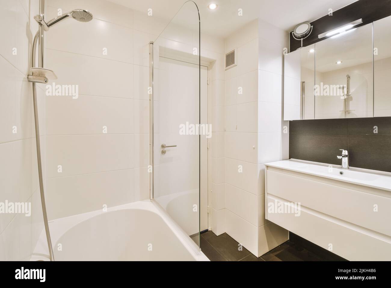 Sinks With Mirrors And Clean Bathtub Located Near Shower Box With Glass