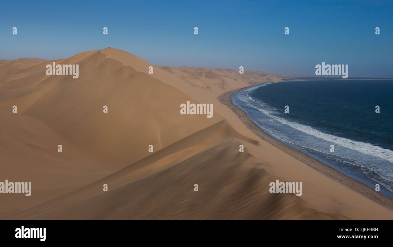 The vast desert landscape of Walvis in Namibia under a clear sky Stock ...
