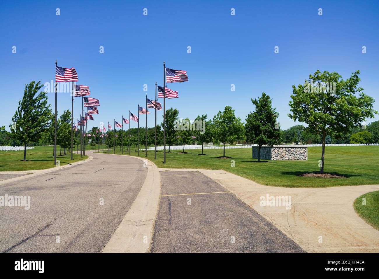 A view of memorial park surrounded by American flags on flag poles ...