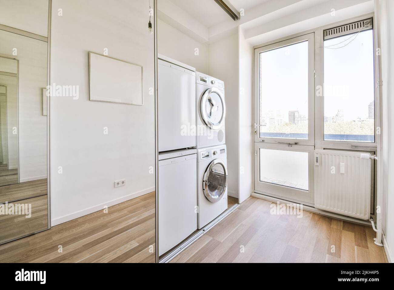 Interior of modern bright laundry room with white walls and dark ...