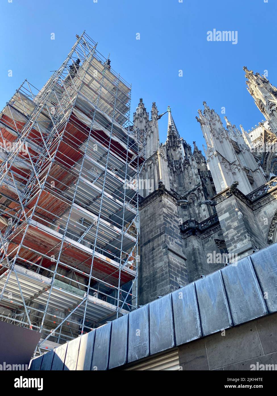 A vertical low angle shot of scaffolding at Cologne Cathedral, Germany ...