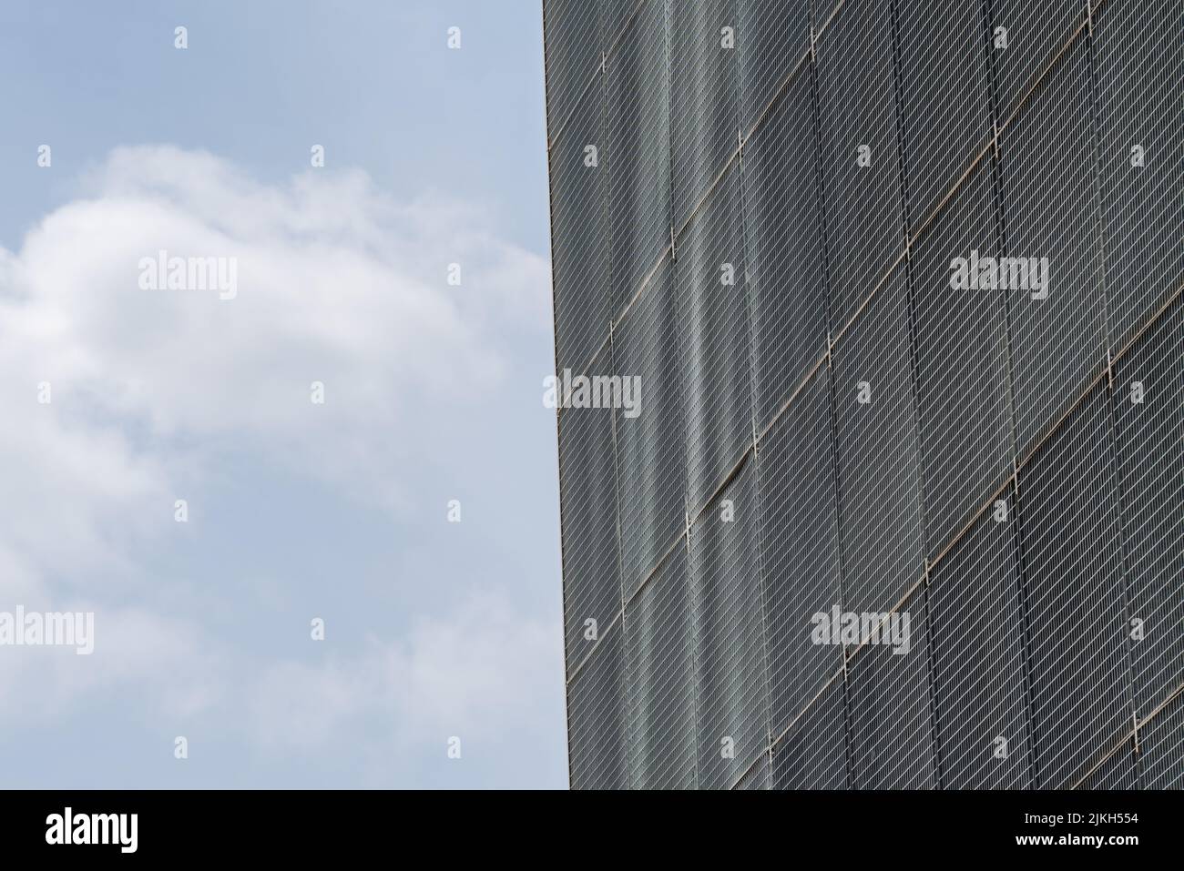 A part of a gray building facade with modern construction and cloudy ...
