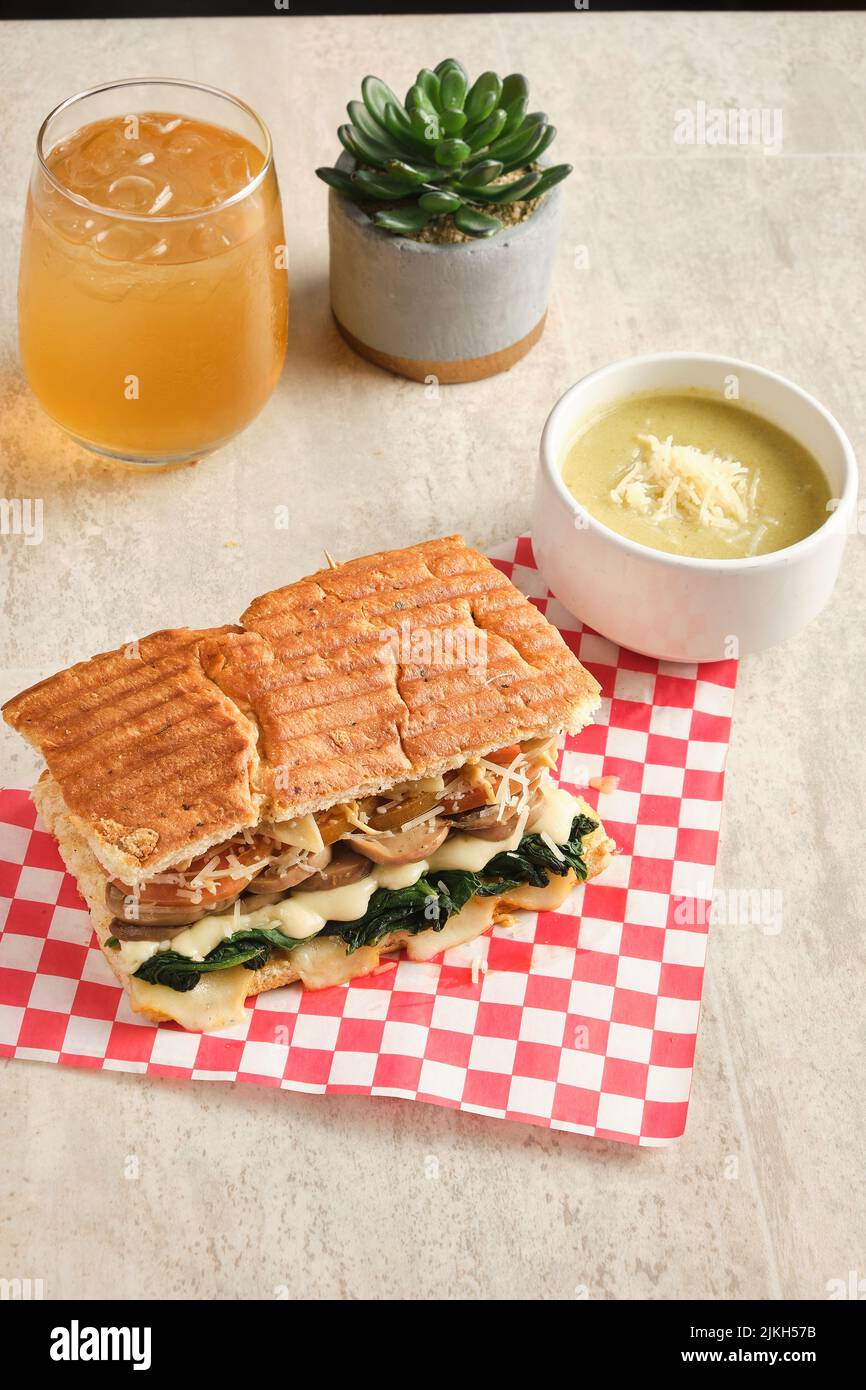 A fresh panini with spinach, mushrooms, cheese and tomatoes Stock Photo ...