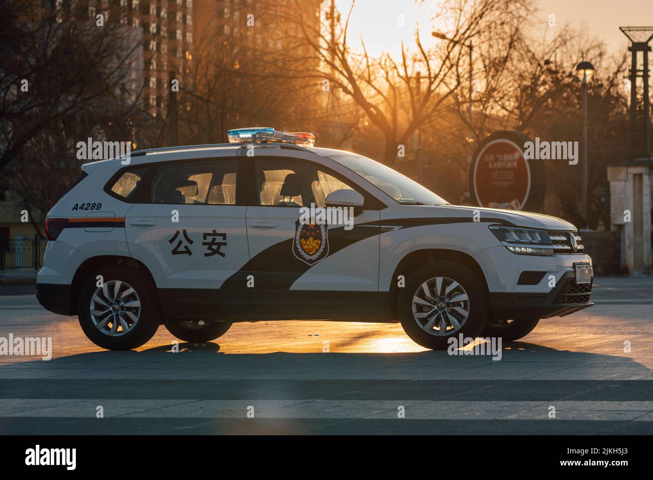 A Police vehicle in downtown Beijing under orange sunset lights Stock ...