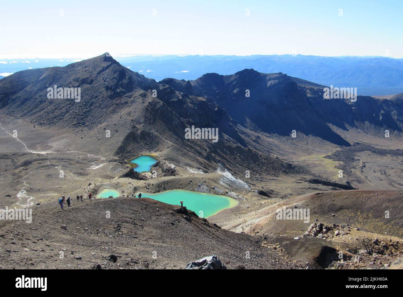 An aerial view of a lake in rocky hills covered with shrubs in ...