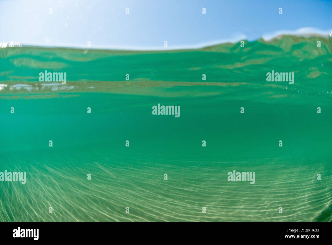 Underwater view of waves moving sand Stock Photo - Alamy