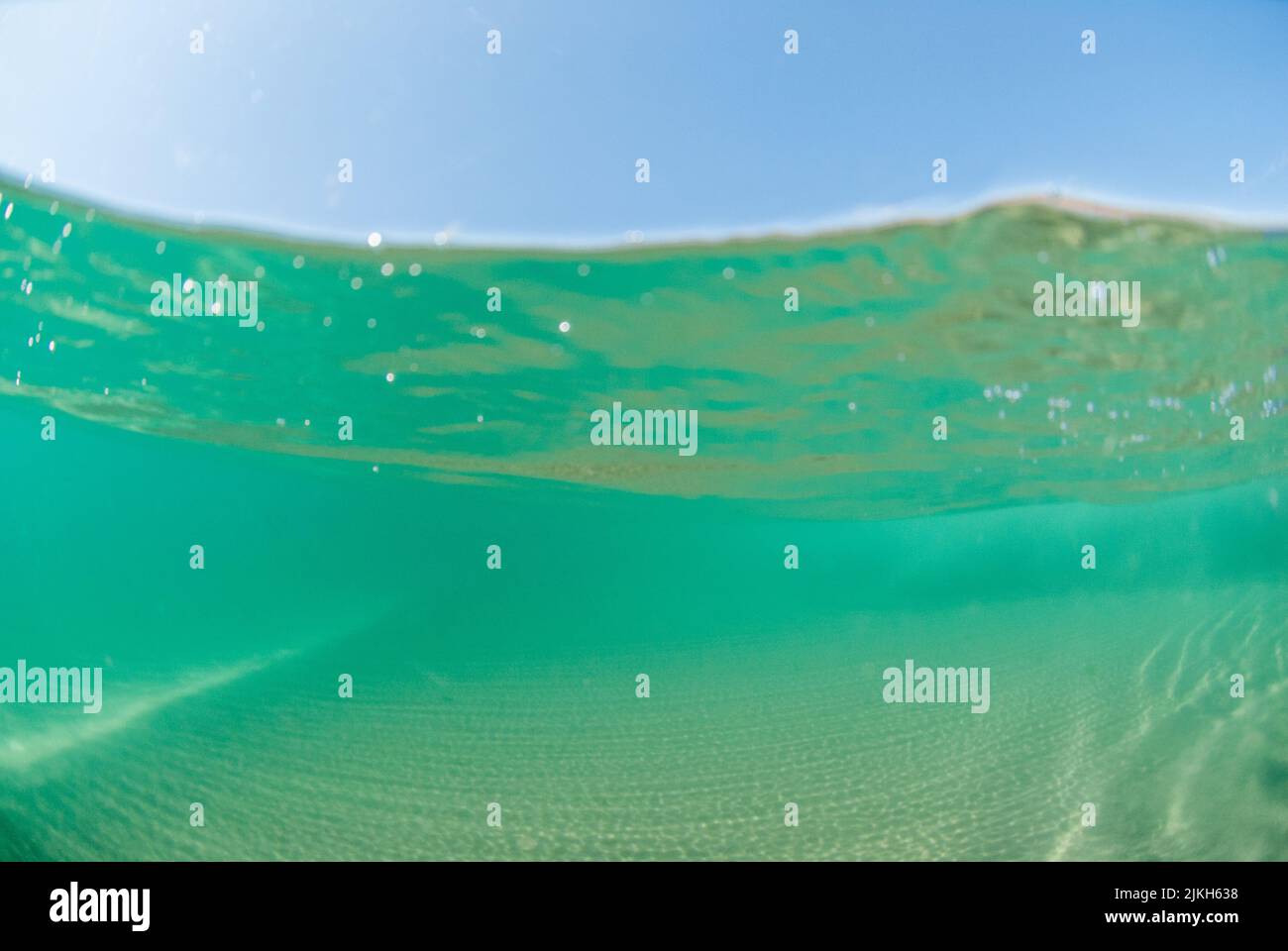 Underwater view of waves moving sand Stock Photo - Alamy