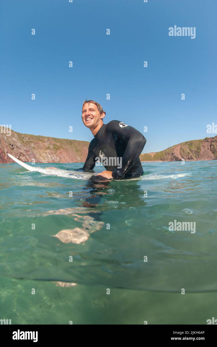 Surfer waiting for waves at West Dale, Pembrokeshire, Wales, UK Stock ...