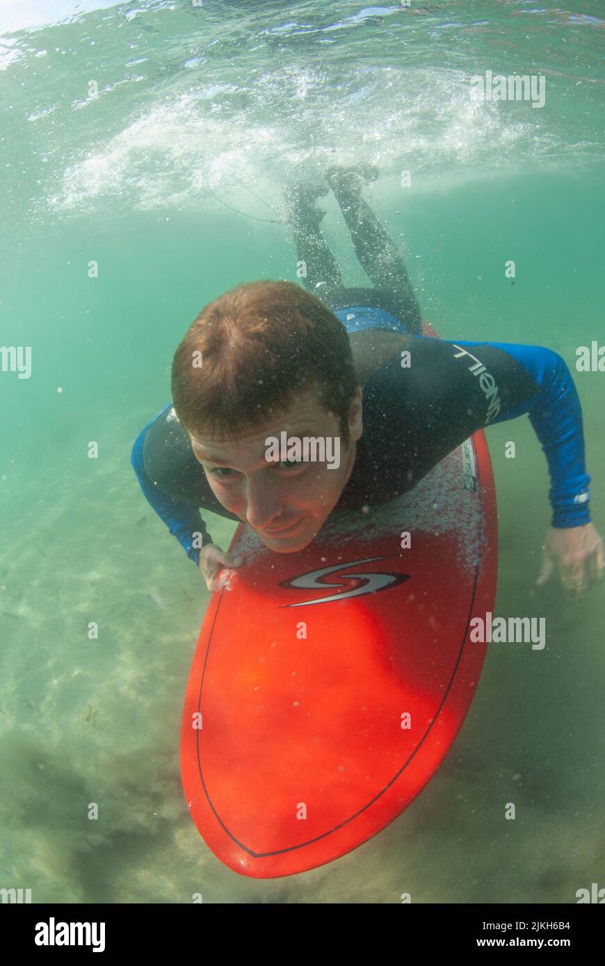 Surfer paddling out into the waves hi-res stock photography and images ...