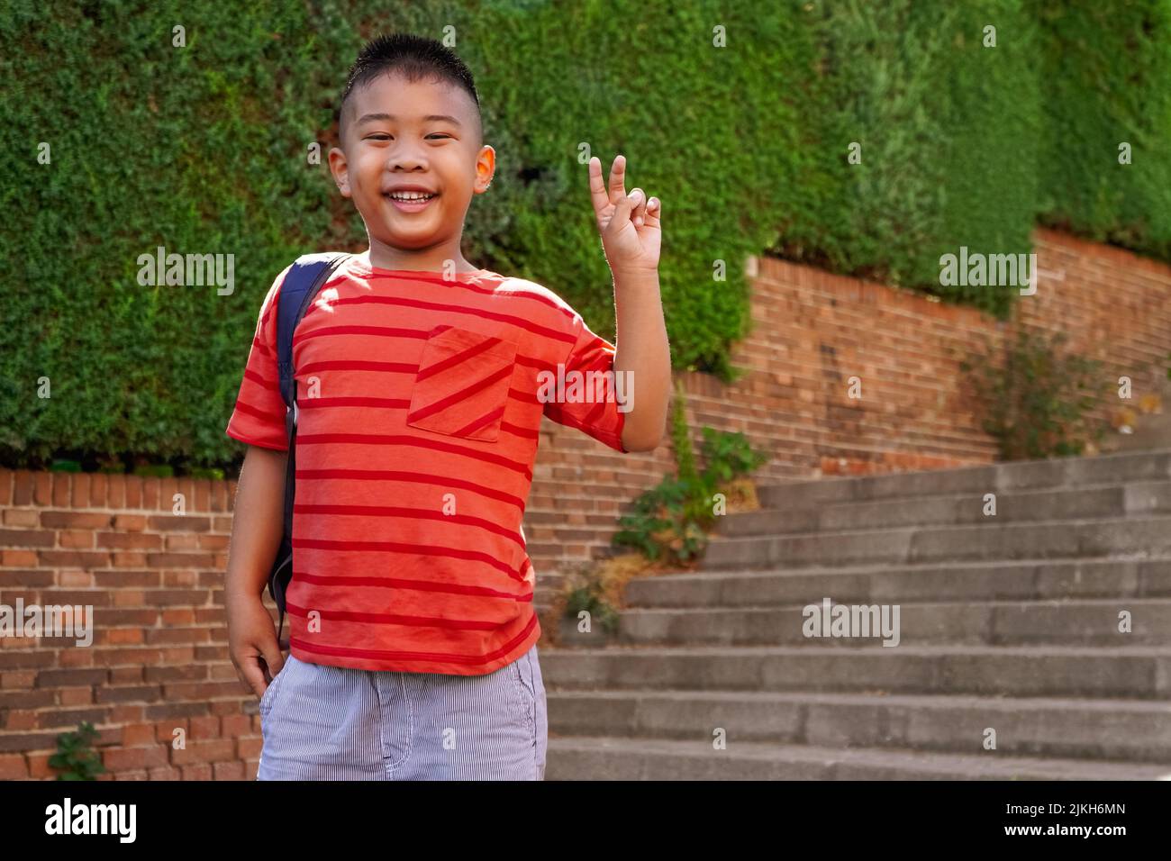 Filipino boy with backpack on the way to school. Back to school concept ...