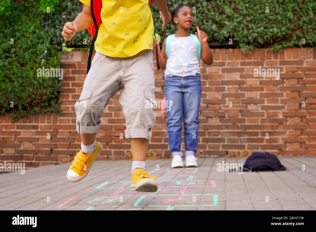 multiethnic kids playing hopscotch on school playground. back to school ...