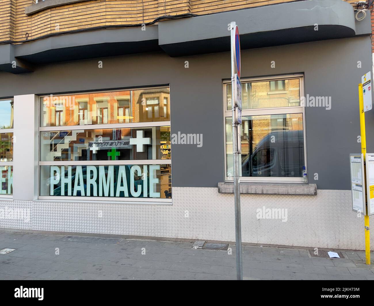 Road sign in front of a pharmacy building in Bruxelles Stock Photo - Alamy