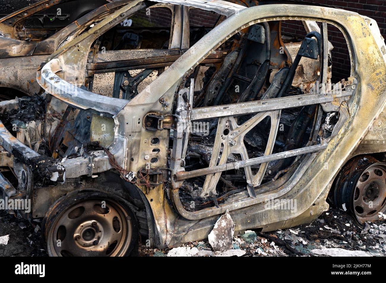 A closeup of burned-up vehicles surrounded by burnt rubble Stock Photo ...