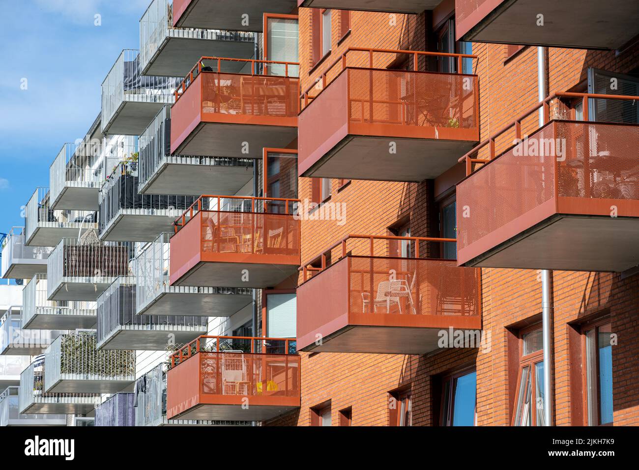 Detail of red and white apartment buildings with many balconies seen in ...