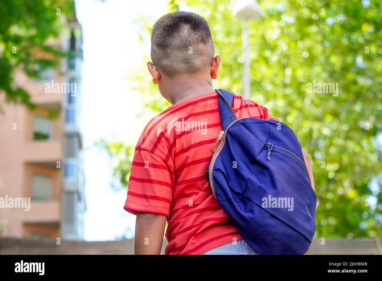 Filipino boy with backpack on the way to school. Back to school concept ...