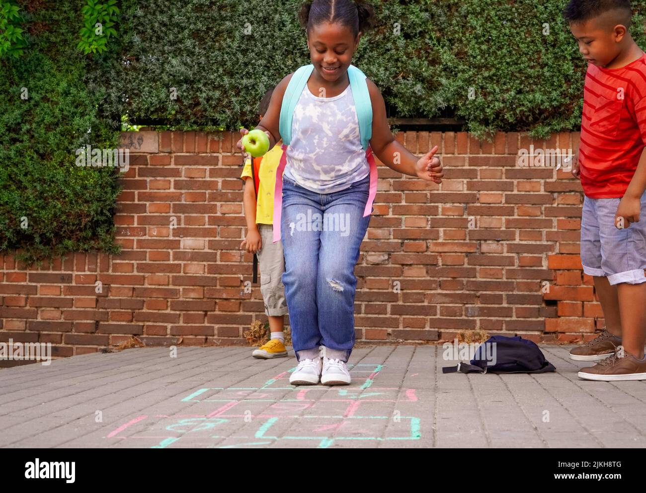 multiethnic kids playing hopscotch on school playground. back to school ... multiethnic kids playing hopscotch on school playground. back to school ...