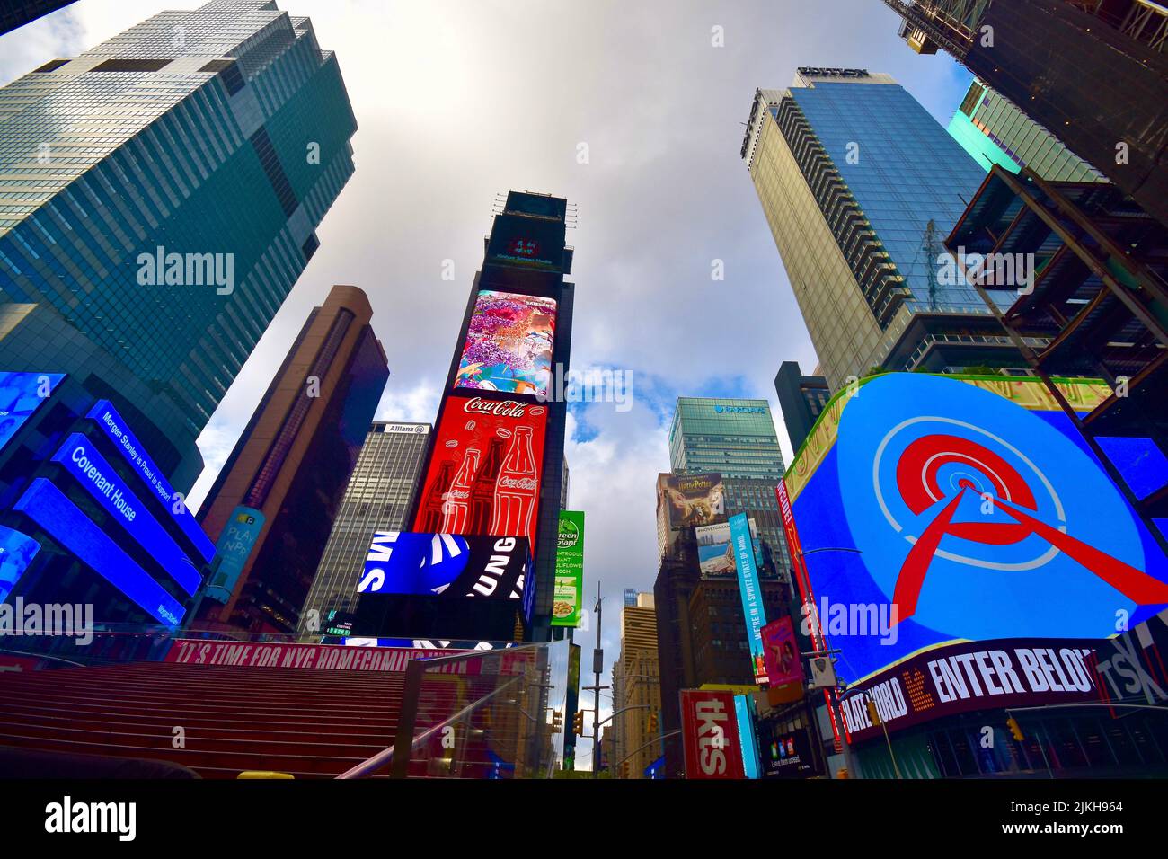 A low angle shot of skyscrapers illuminated by advertisements in Time ...
