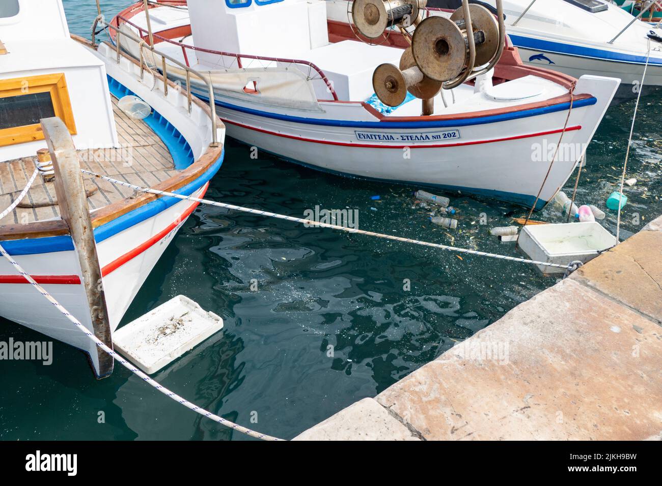 A littered dirty boat docking station with a pieces of trash in the ...
