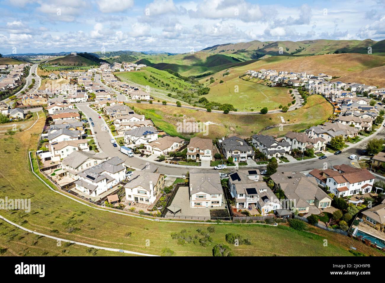 A panoramic view of countryside houses and nature under the clouds ...