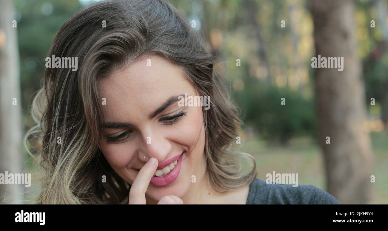 Authentic girl scratches nose Stock Photo - Alamy