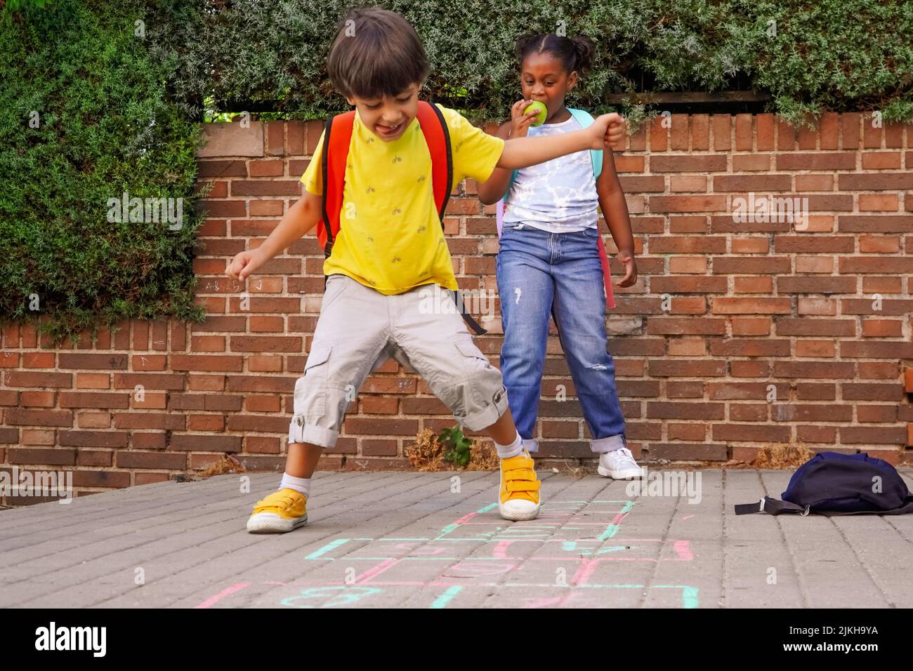 multiethnic kids playing hopscotch on school playground. back to school ...