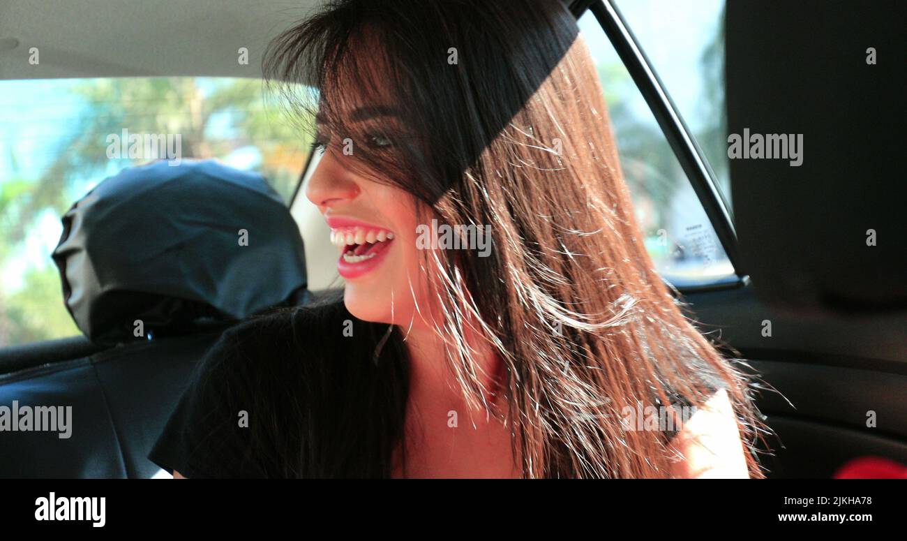Candid authentic laugh of girl in the back seat of a car smiling Joyful ...