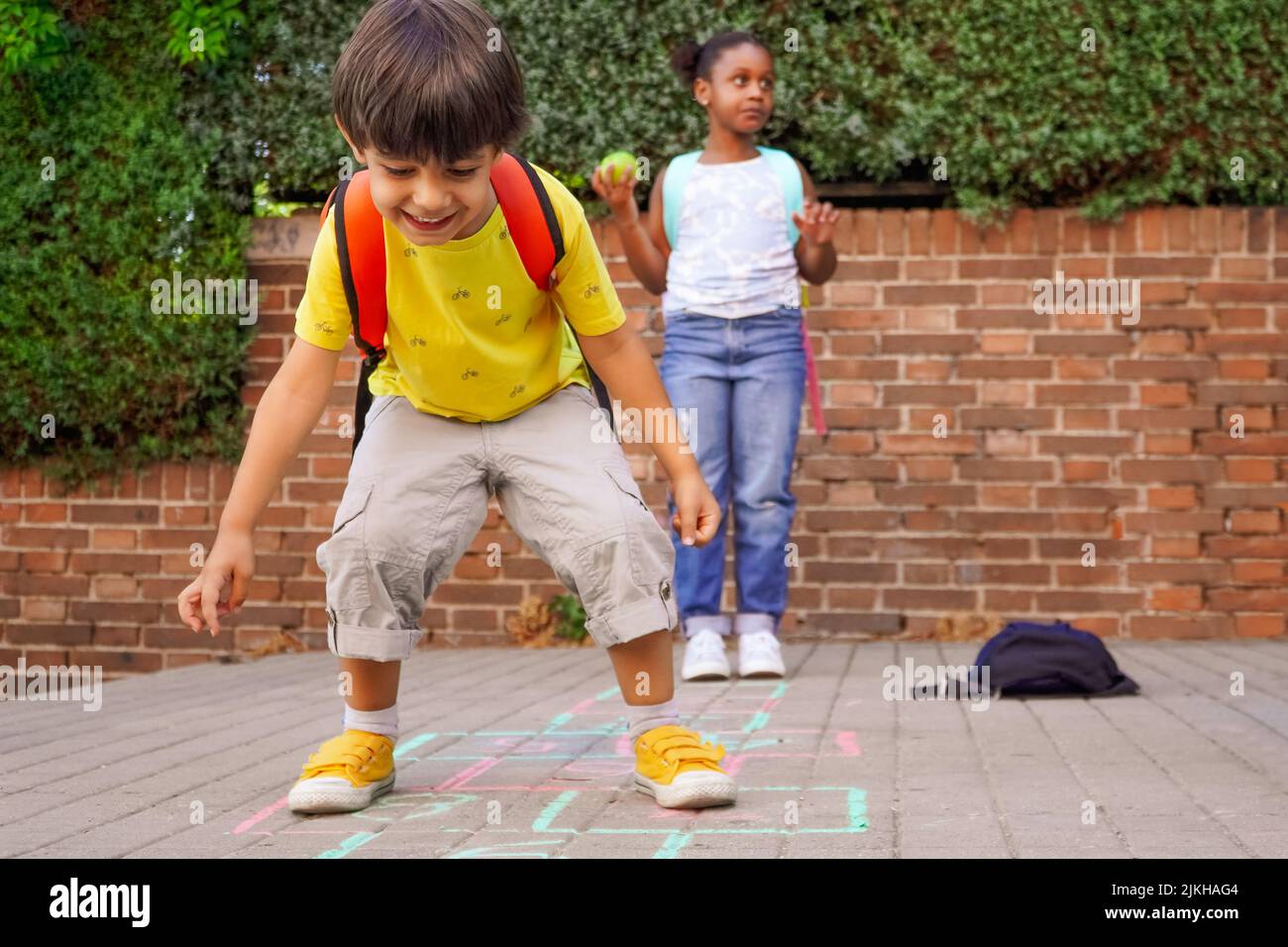 multiethnic kids playing hopscotch on school playground. back to school ...