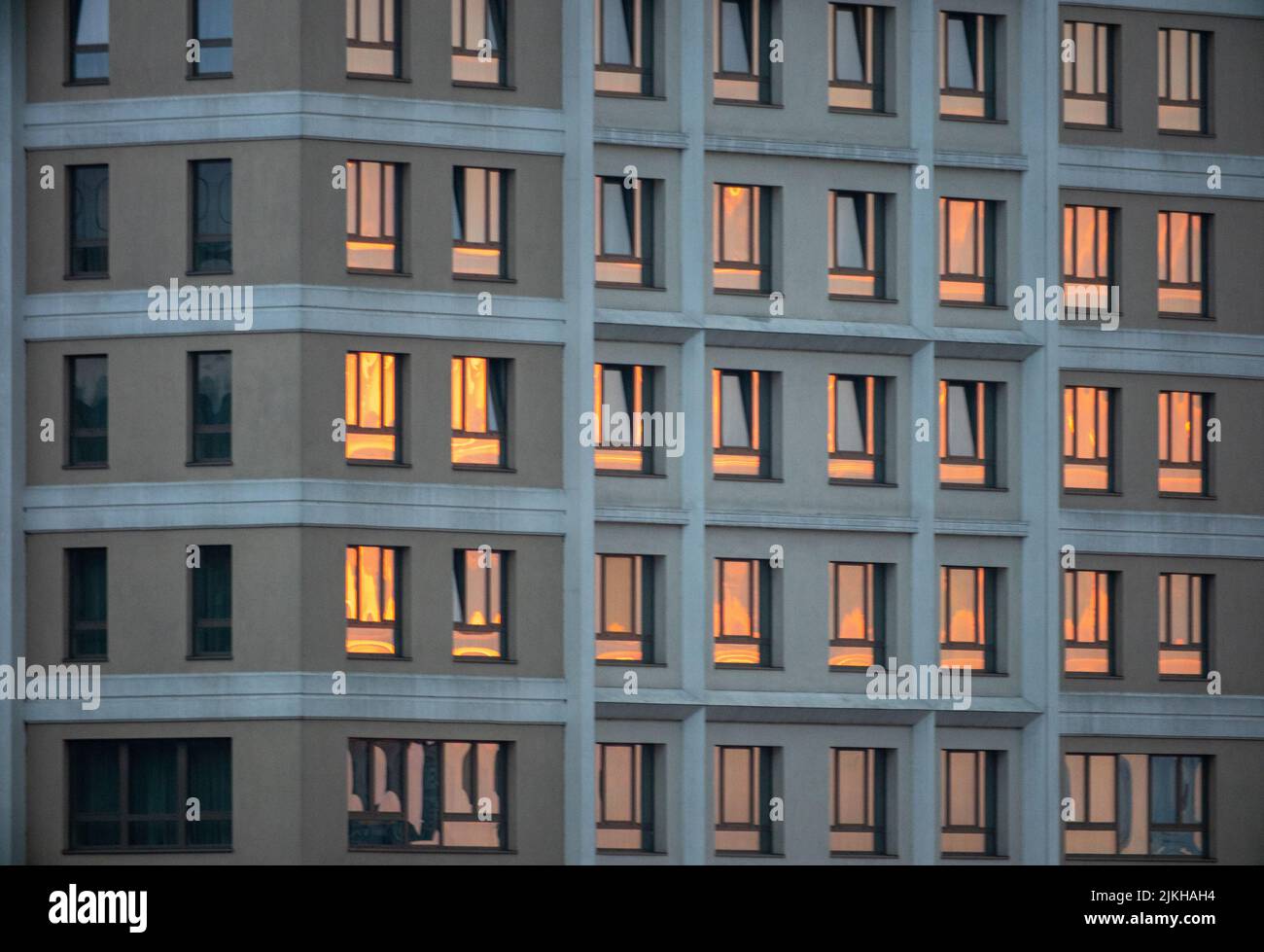 The illuminated windows of the International Hotel at sunset in Iasi ...