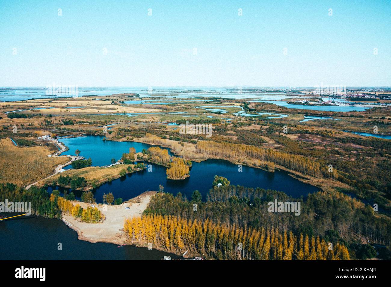 A beautiful view of ponds with fields under the clear blue sky Stock ...