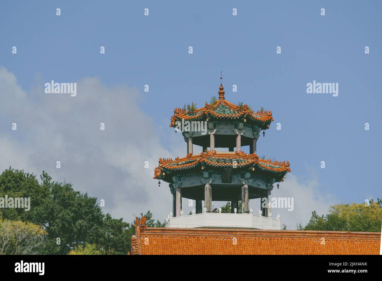 A beautiful view of a Chinese ancient watchtower with trees in the ...